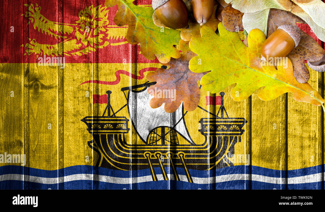 New Brunswick flag on autumn wooden background with leaves and good ...