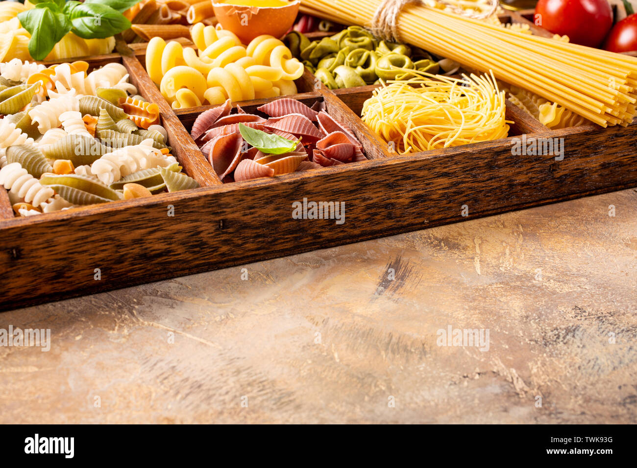 Assorted colorful italian pasta in wooden box Stock Photo - Alamy