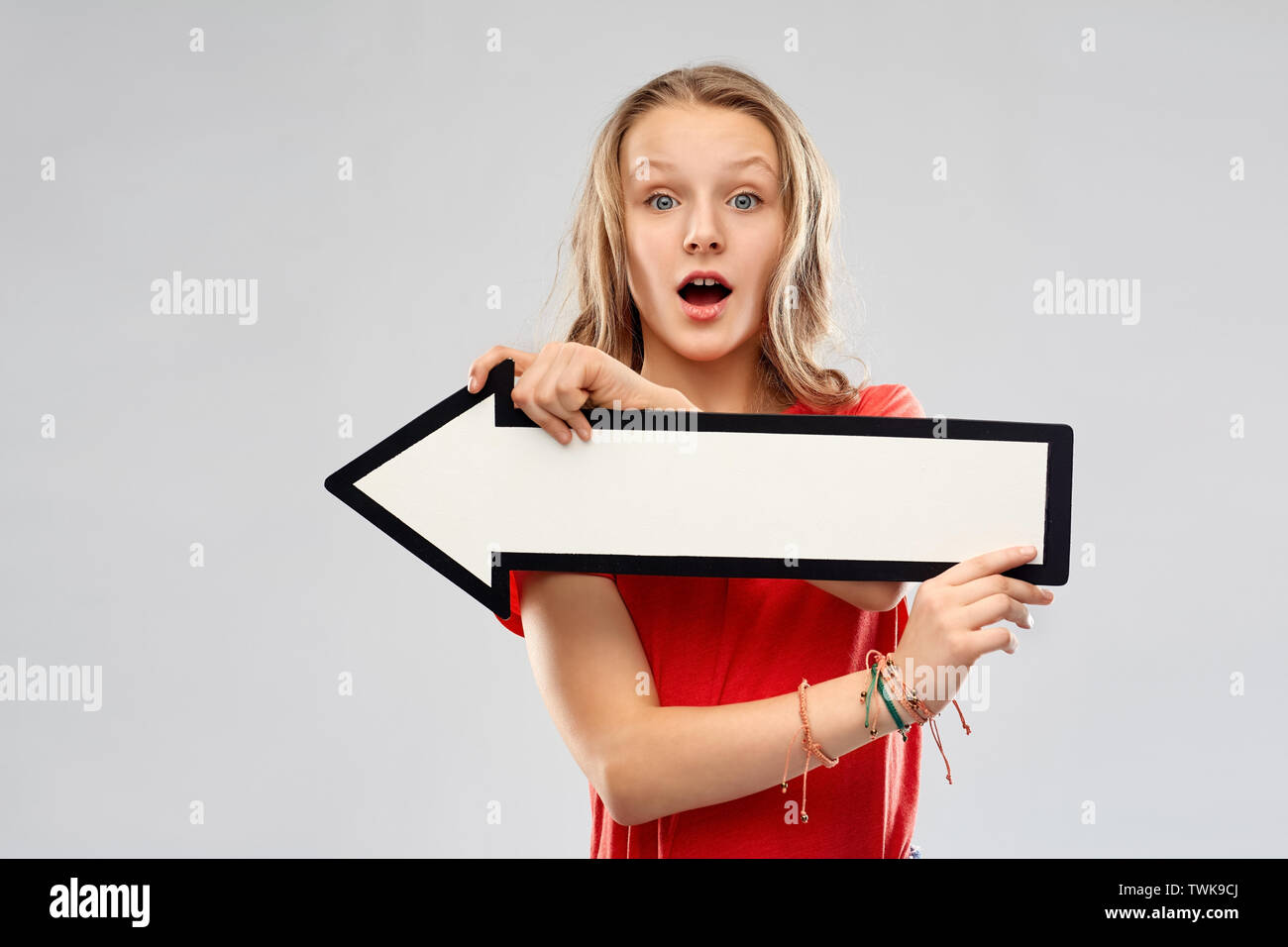 teenage girl with arrow showing direction Stock Photo - Alamy