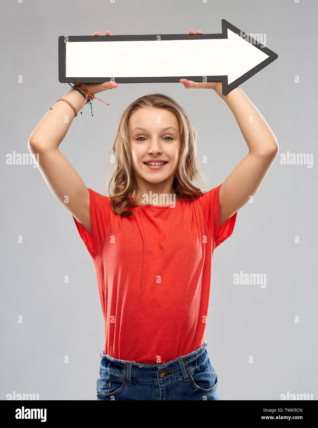 smiling teenage girl with arrow showing direction Stock Photo - Alamy