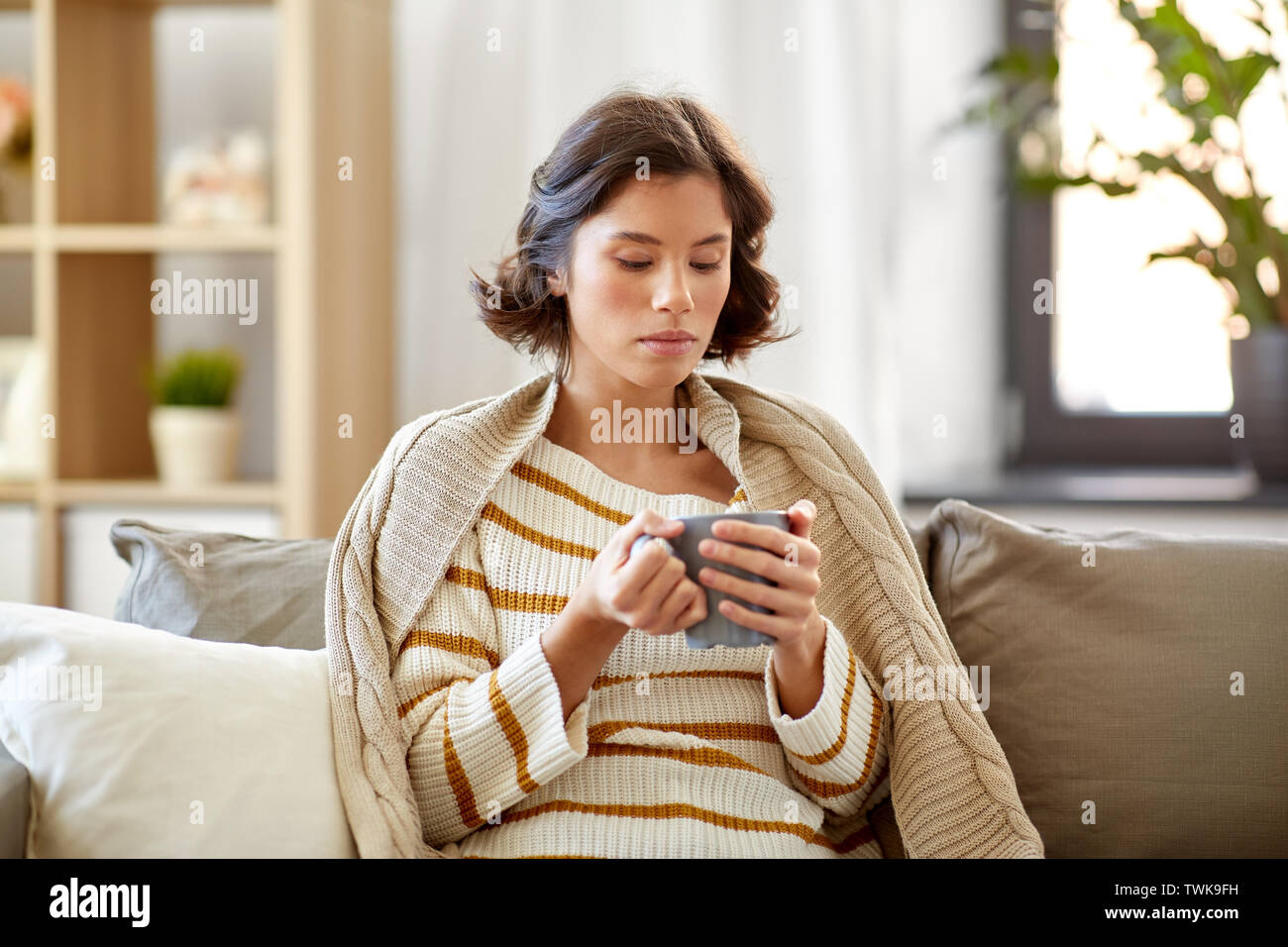 Sad young female cup tea hi-res stock photography and images - Alamy
