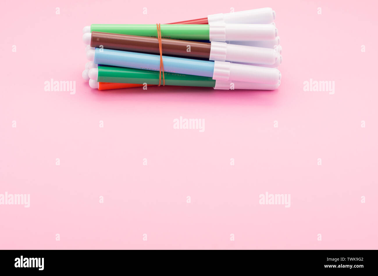 felt tip pen colored pencils on a pink surface - copy space Stock Photo ...