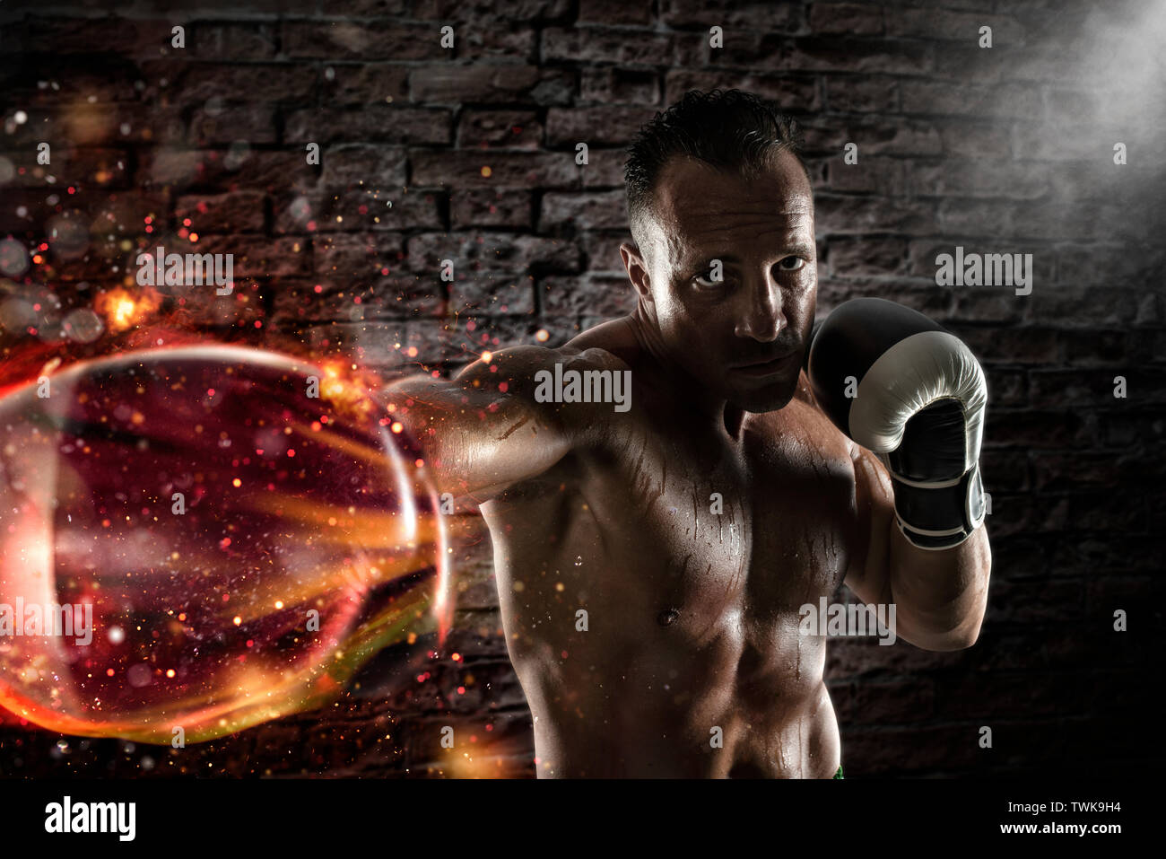 Confident athletic boxer with fiery boxing gloves Stock Photo - Alamy
