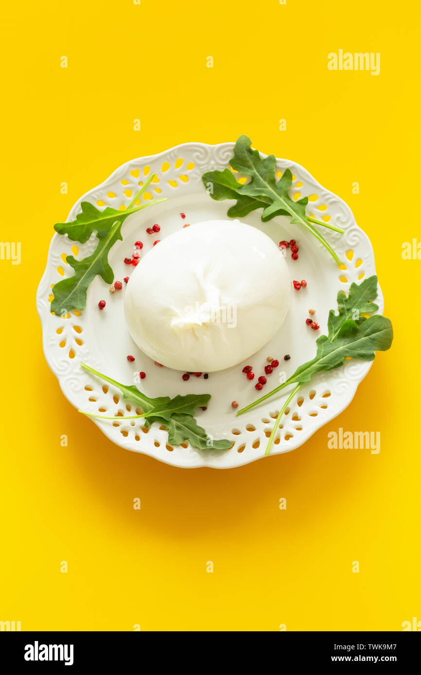 Burrata, Italian cheese with tomatoes, spices, argugula and olive oil ...