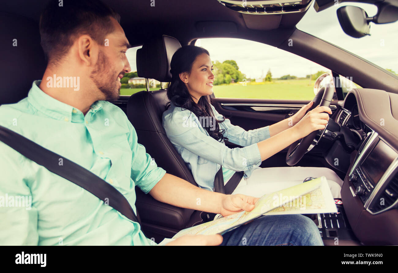 happy man and woman with road map driving in car Stock Photo - Alamy