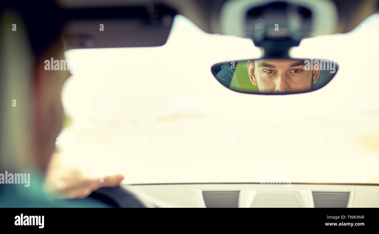 rearview mirror reflection of man driving car Stock Photo - Alamy