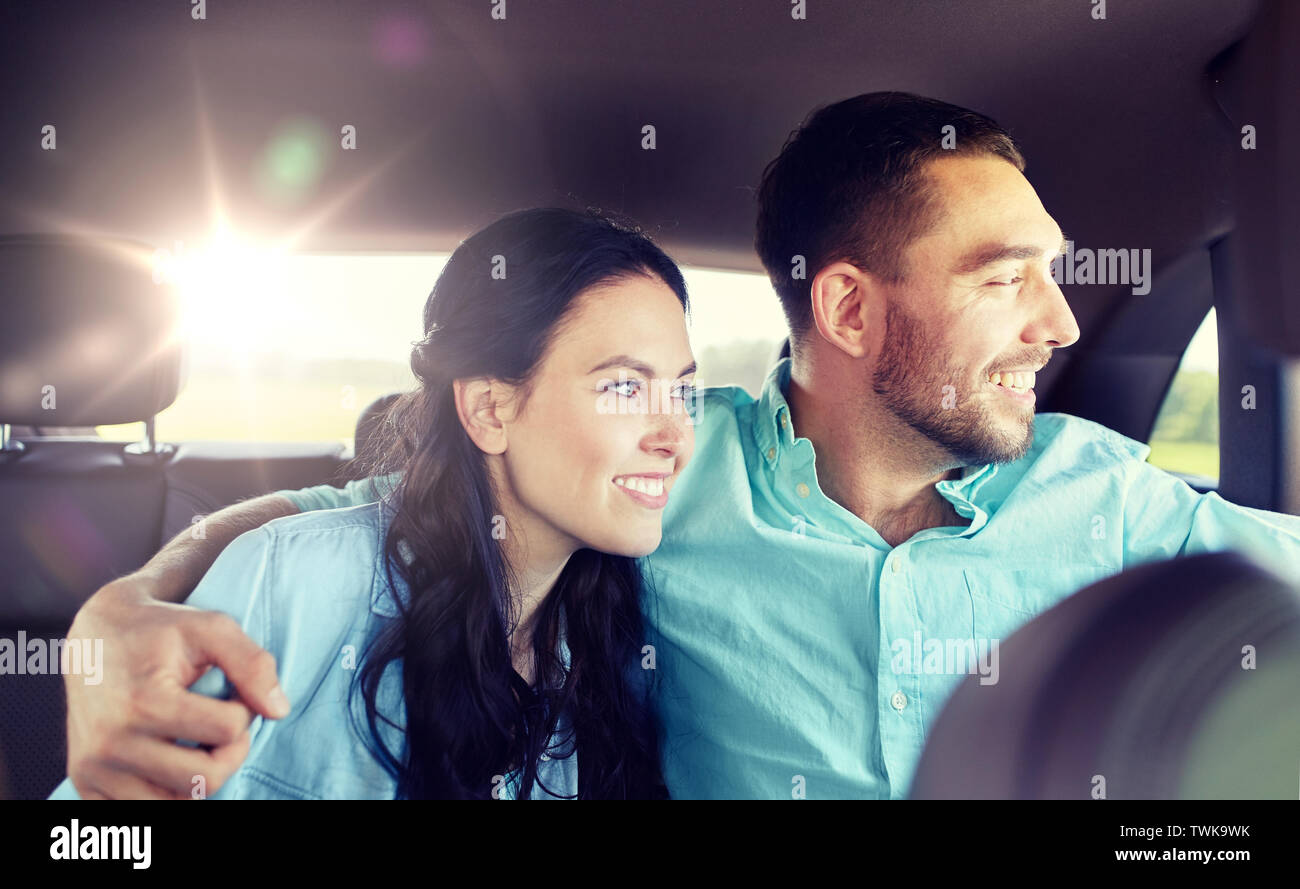happy man and woman hugging on taxi back seat Stock Photo - Alamy