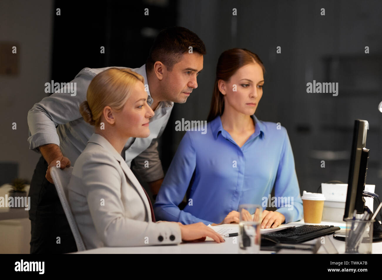 business team with computer working late at office Stock Photo - Alamy