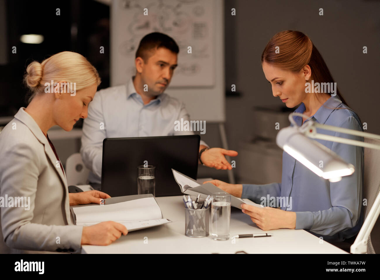 business team with laptop working at night office Stock Photo - Alamy