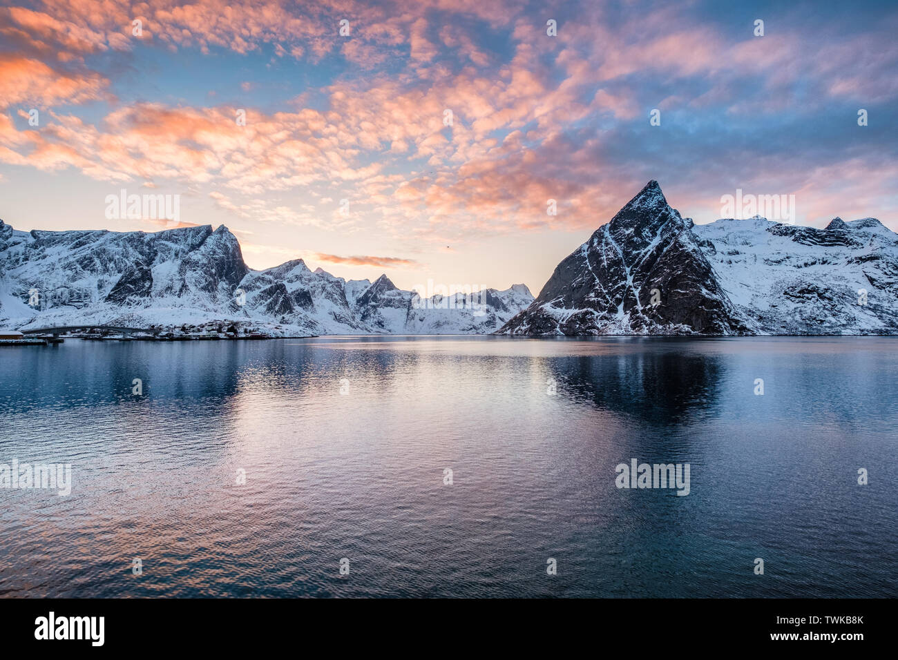 Mountain range with fluffy colorful clouds in arctic ocean at sunset ...