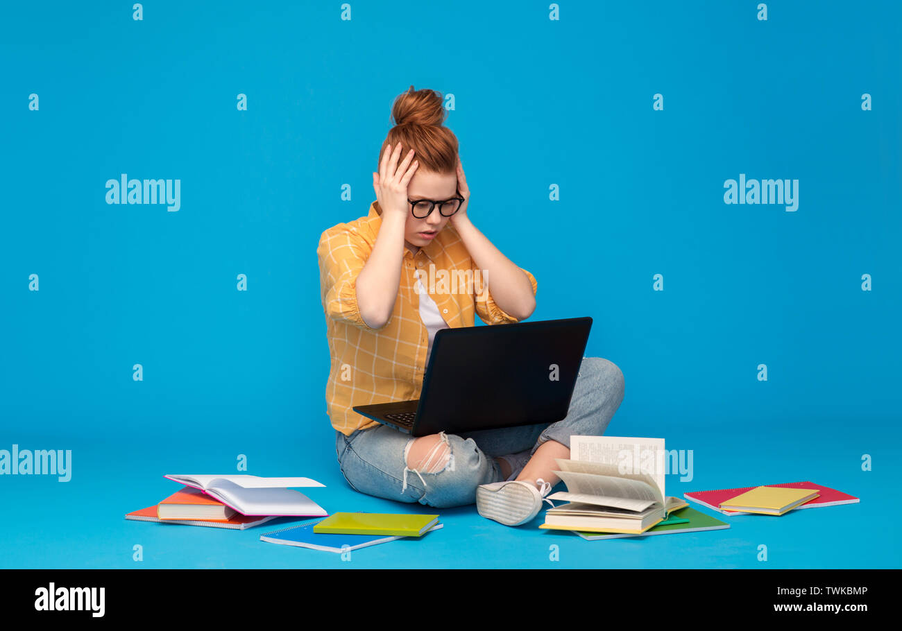 stressed student girl with laptop and books Stock Photo - Alamy