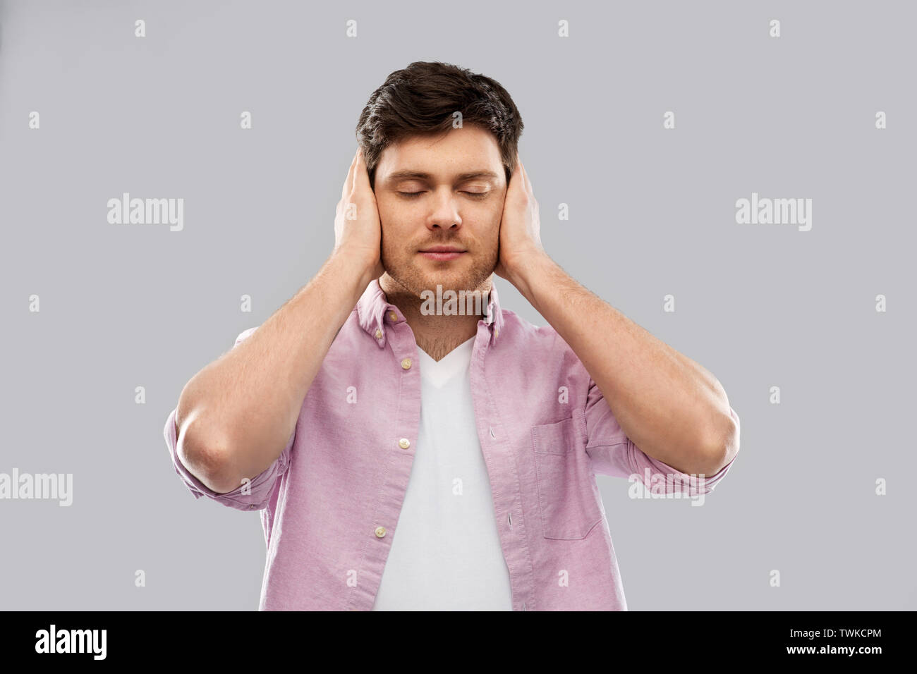 man closing ears by hands Stock Photo - Alamy