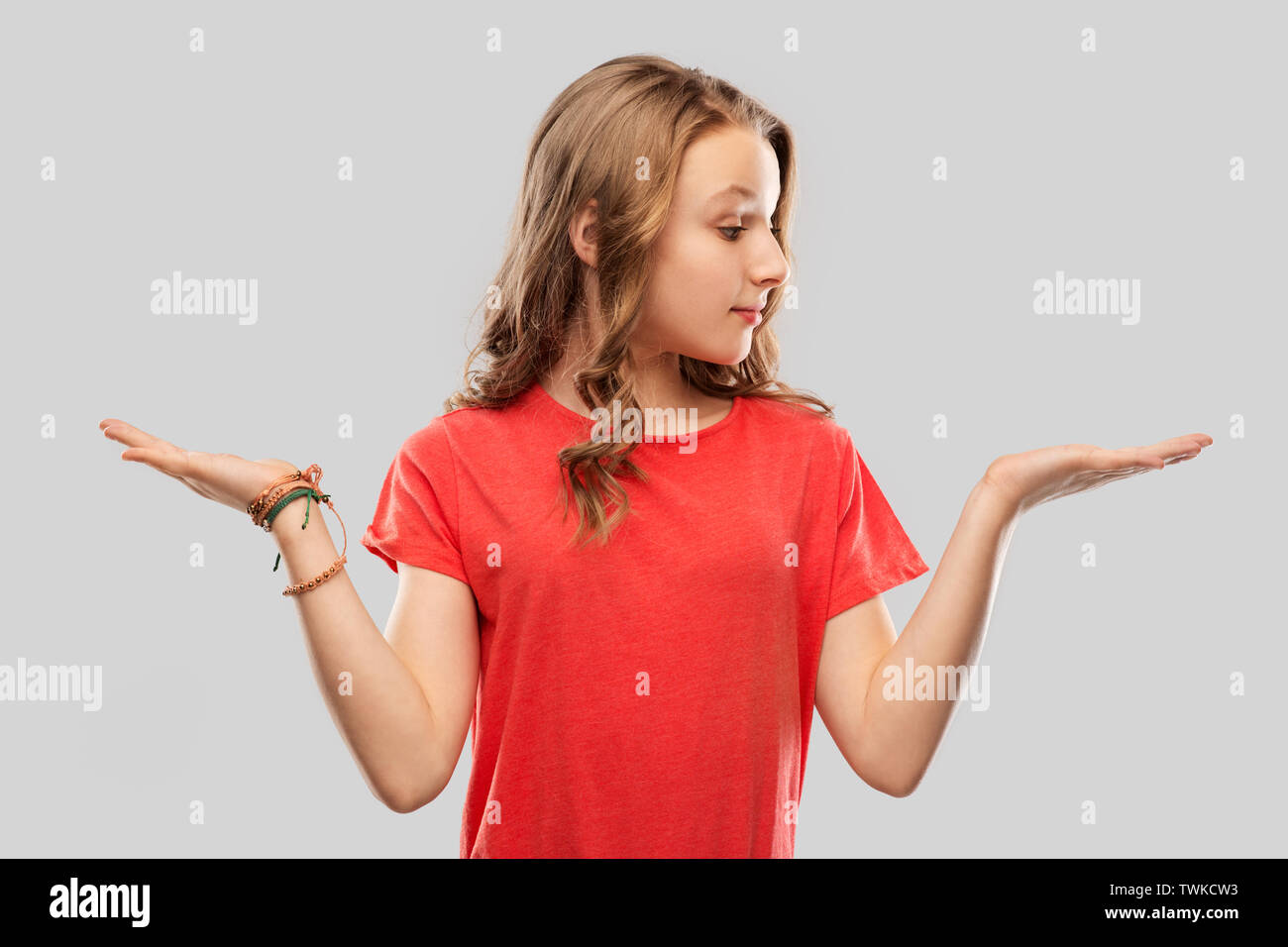 smiling teenage girl holding empty hand Stock Photo - Alamy