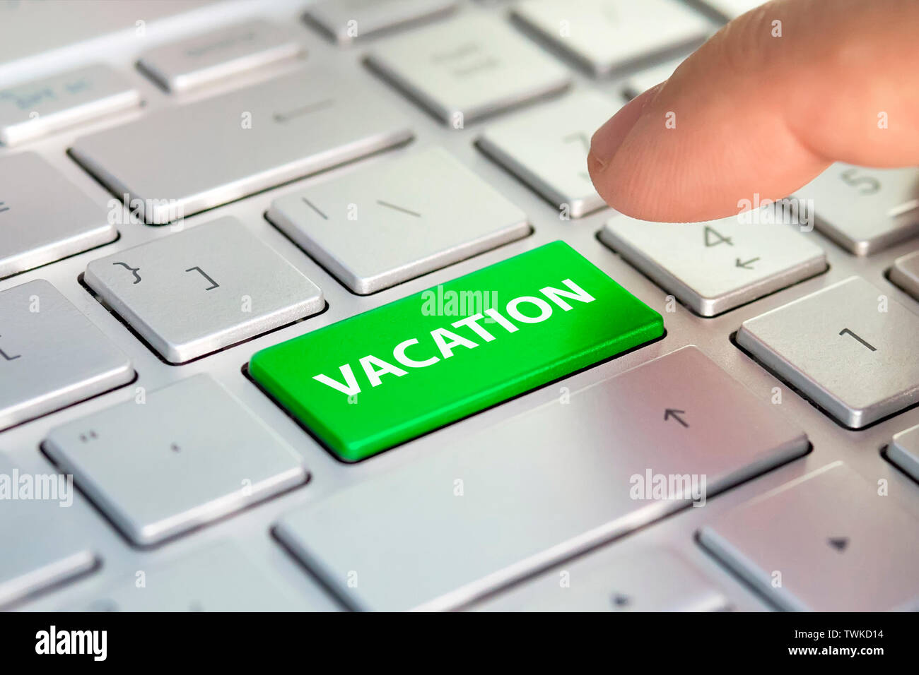 vacation word on computer keyboard button. Finger presses the color ...