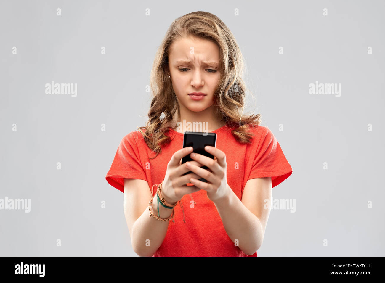 sad teenage girl using smartphone Stock Photo - Alamy