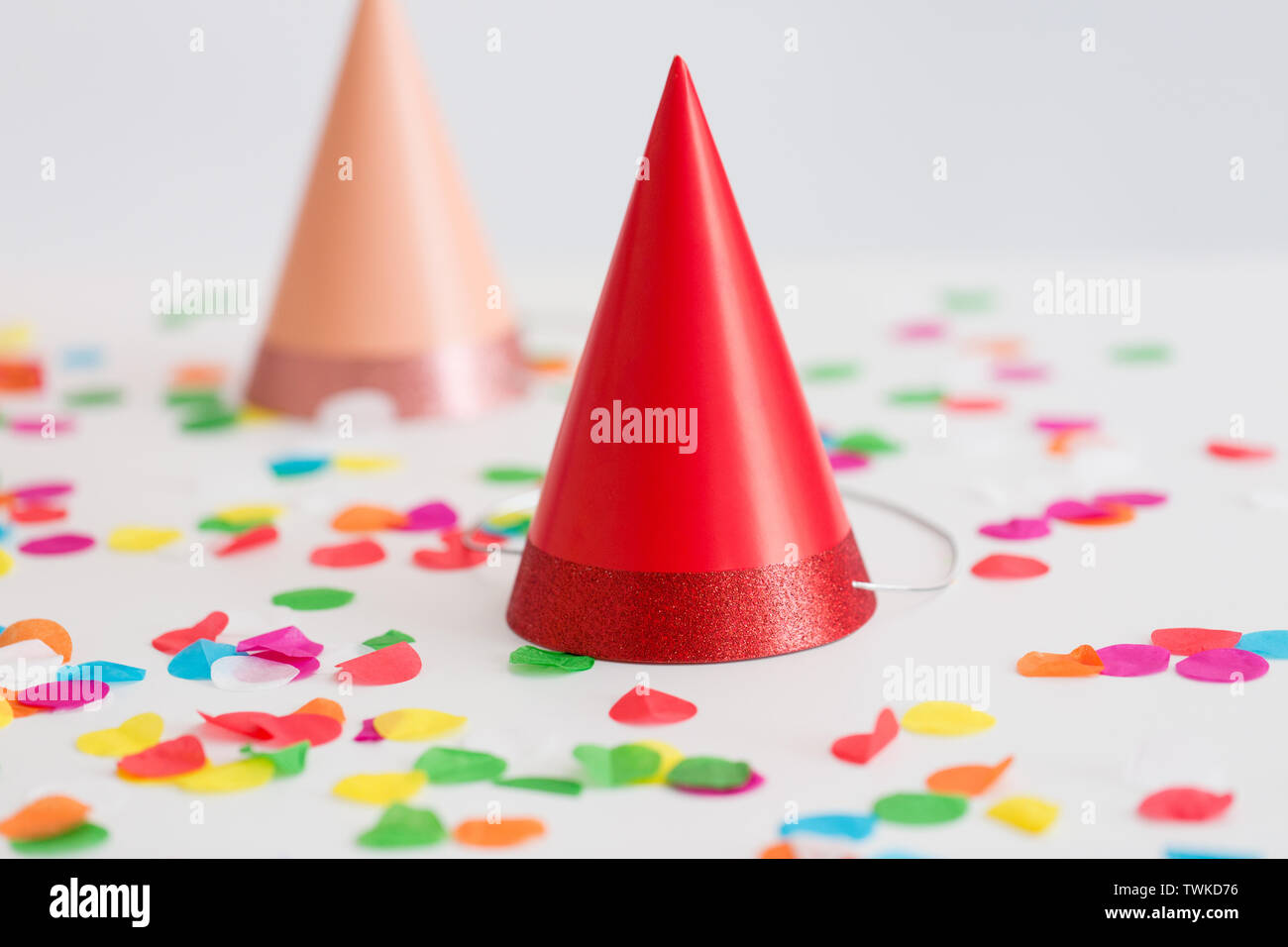 red birthday party cap and confetti Stock Photo - Alamy