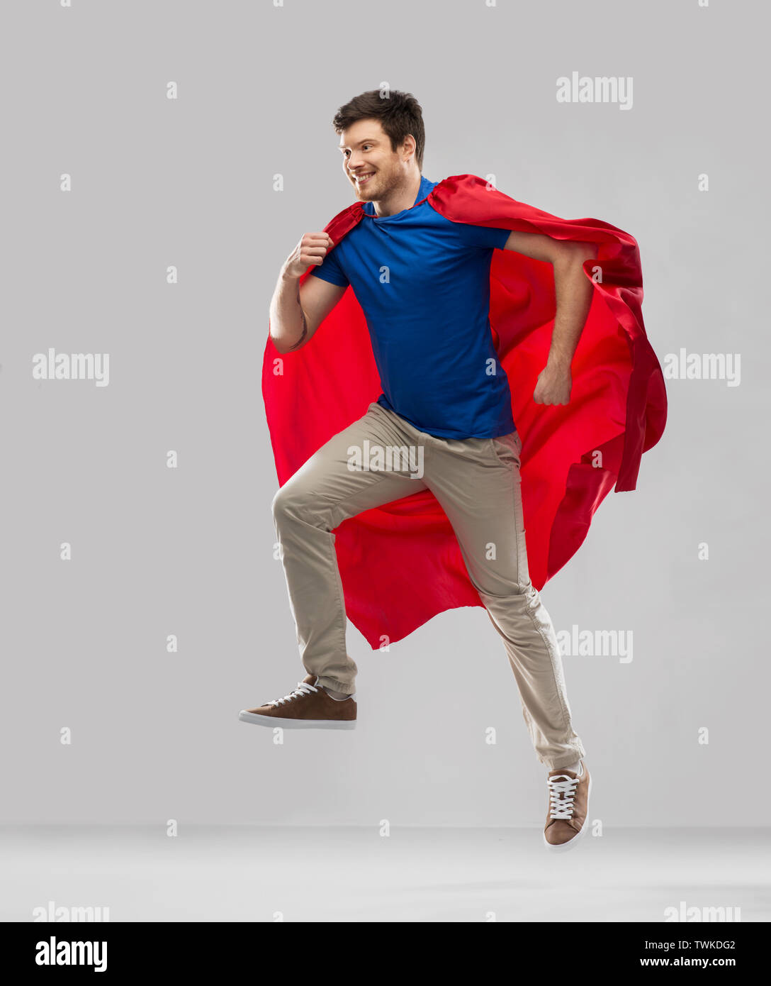man in red superhero cape jumping in air Stock Photo - Alamy