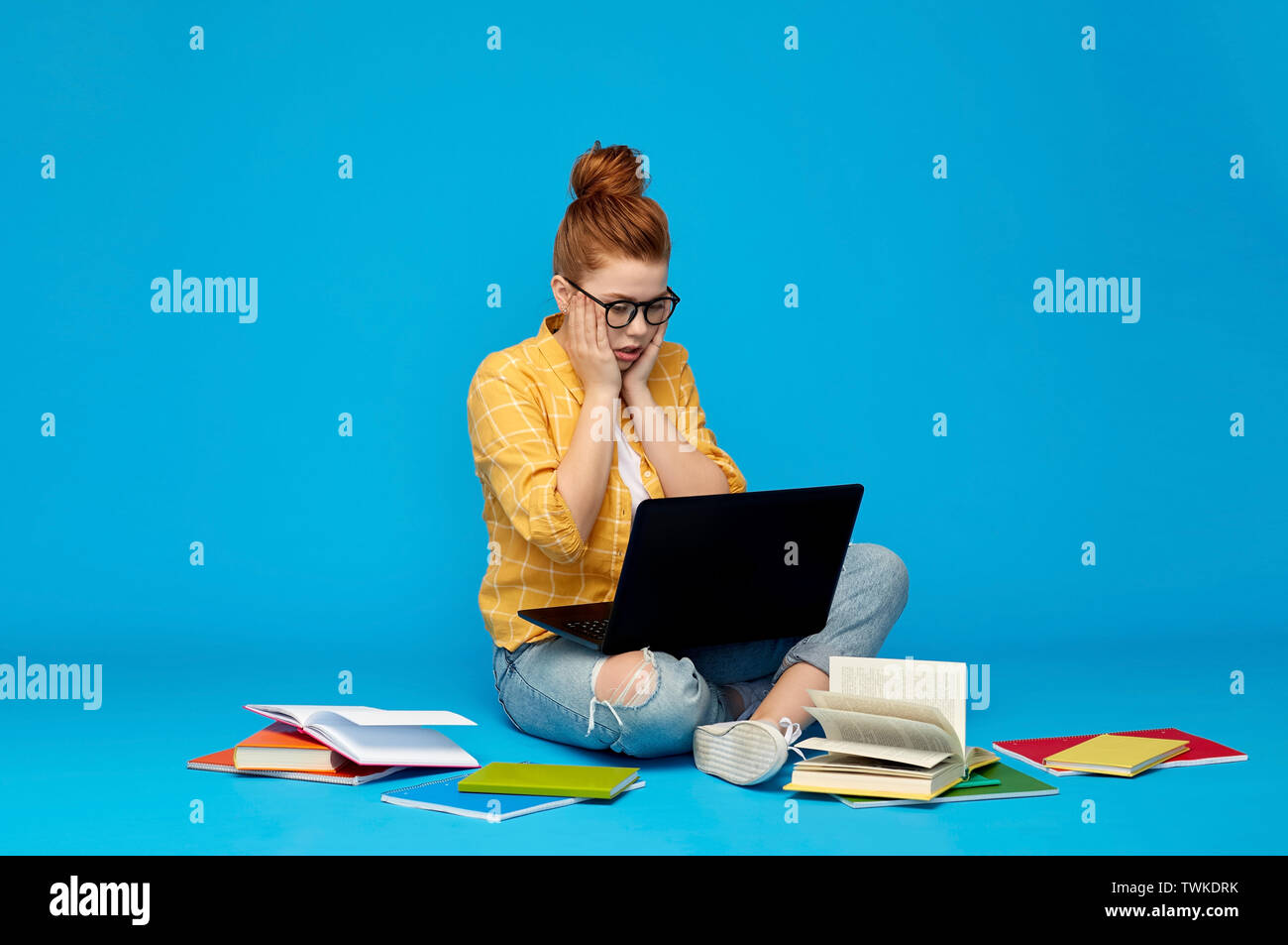 stressed student girl with laptop and books Stock Photo - Alamy