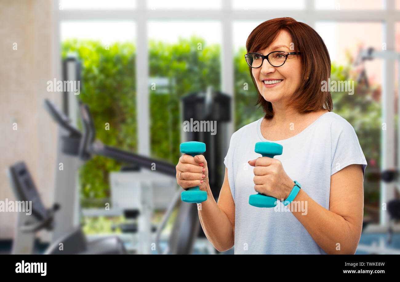 happy old woman with dumbbells exercising in gym Stock Photo - Alamy