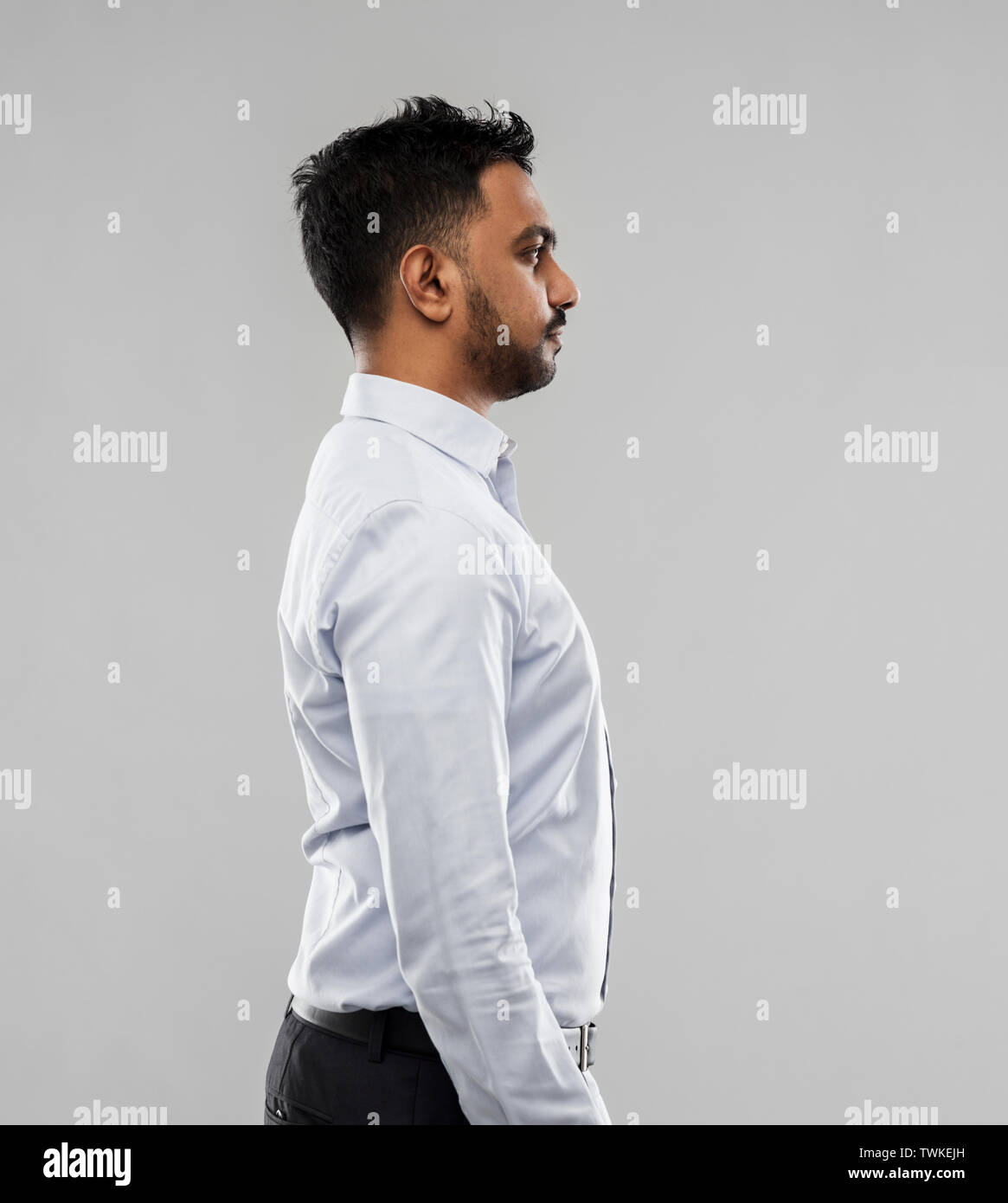 indian businessman side view over grey background Stock Photo - Alamy