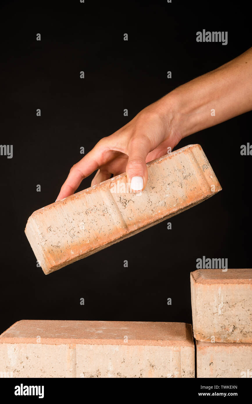 Female hand building a wall, an immigration concept Stock Photo - Alamy