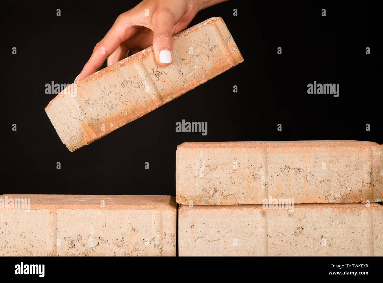 Female hand building a wall, an immigration concept Stock Photo - Alamy