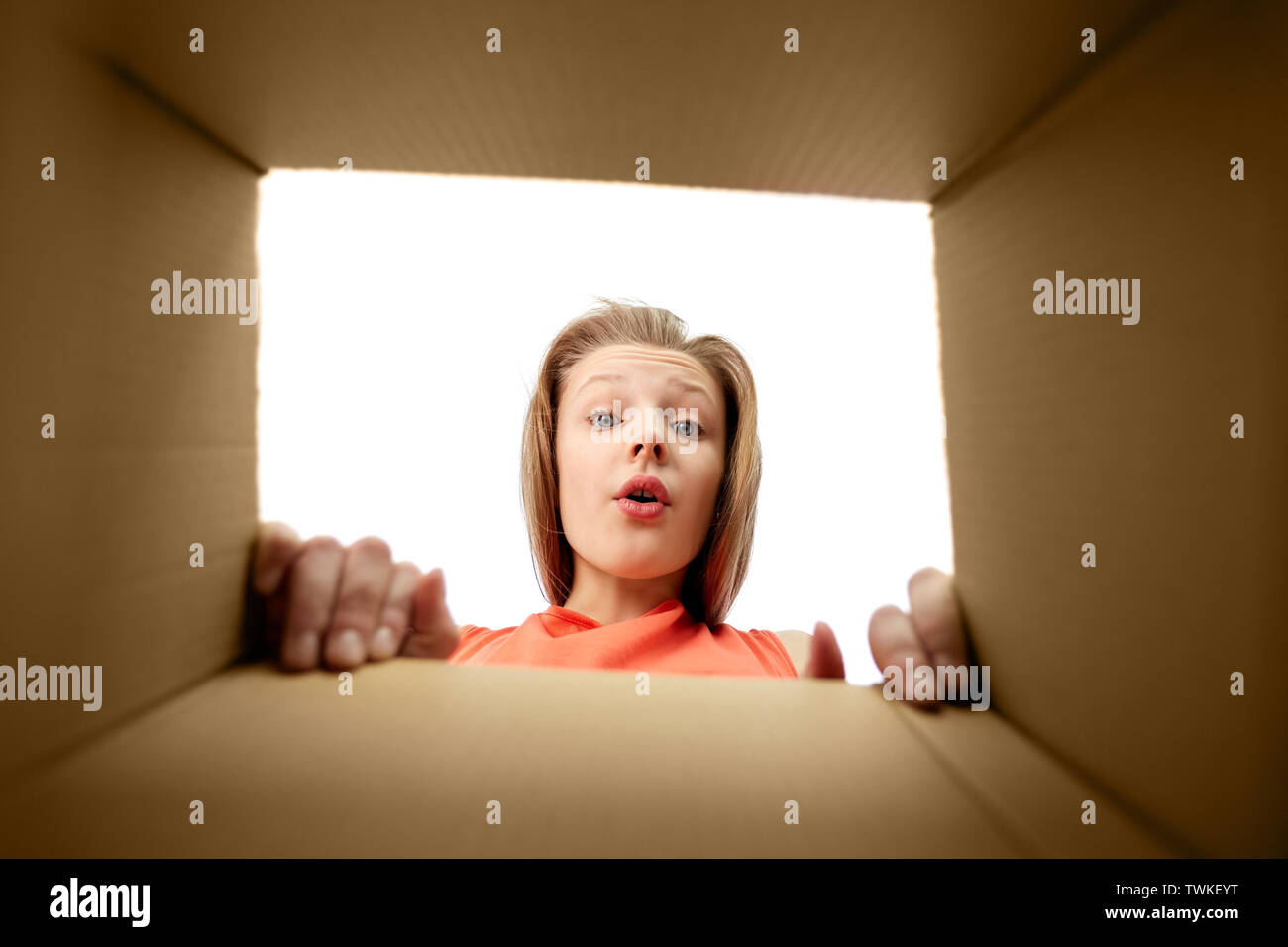 happy surprised girl looking into gift box Stock Photo - Alamy