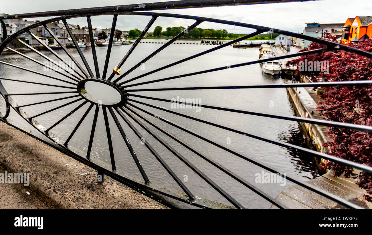Close up of a blacksmith railing with a padlock and the river Shannon ...
