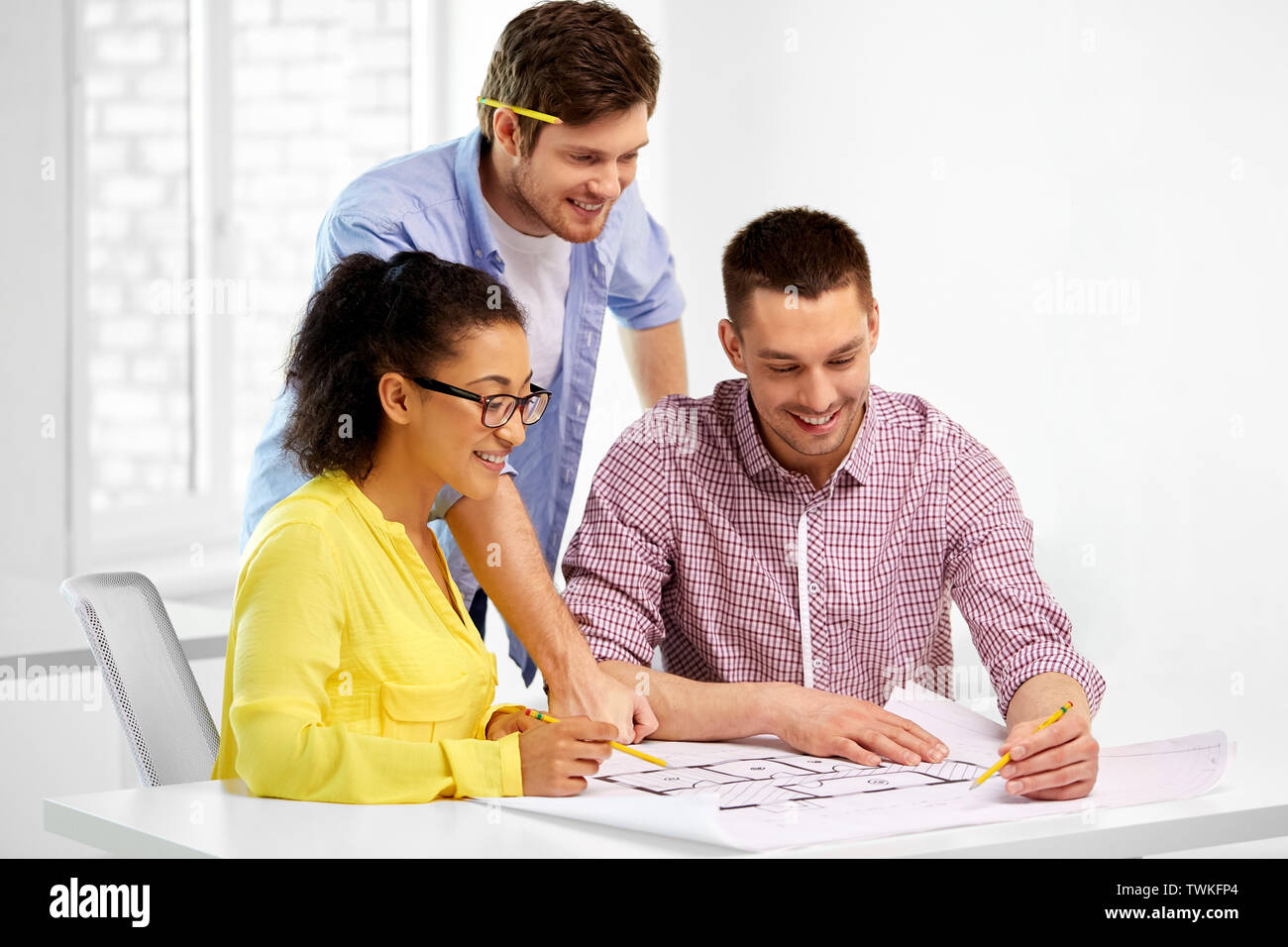 creative team with blueprint working at office Stock Photo - Alamy
