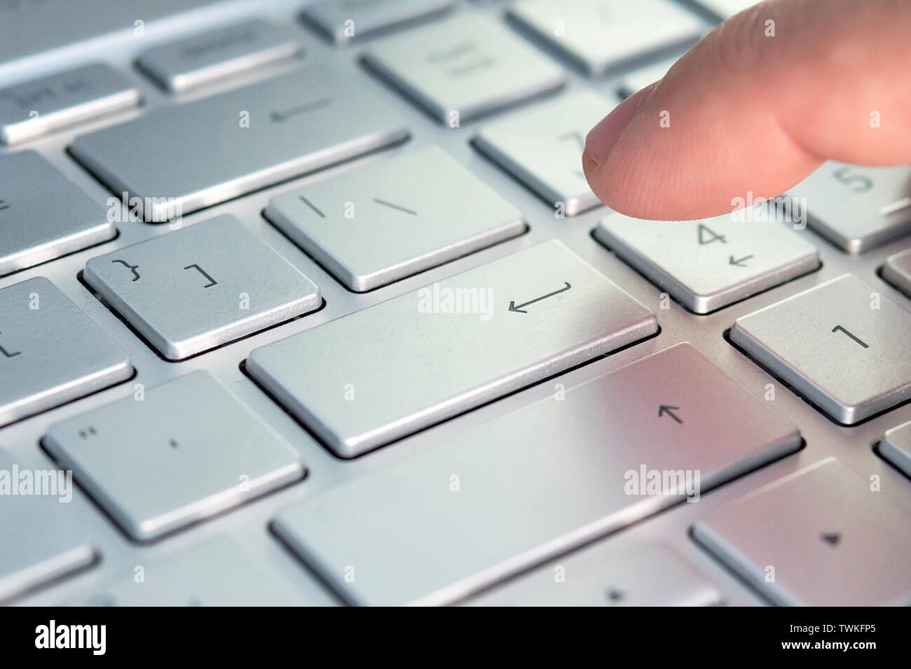 Finger pushing the button of keyboard. Click on the gray ultrabook key ...