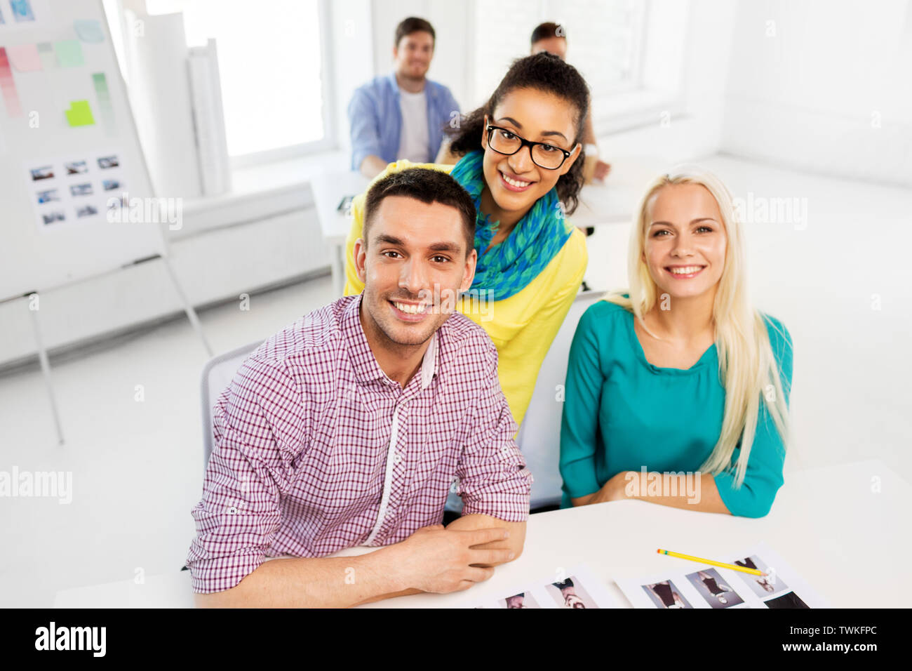 creative team with photos at model agency office Stock Photo - Alamy