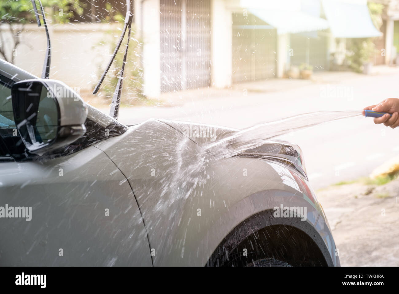 Manual washing car with pressure water hose on white car Stock Photo ...