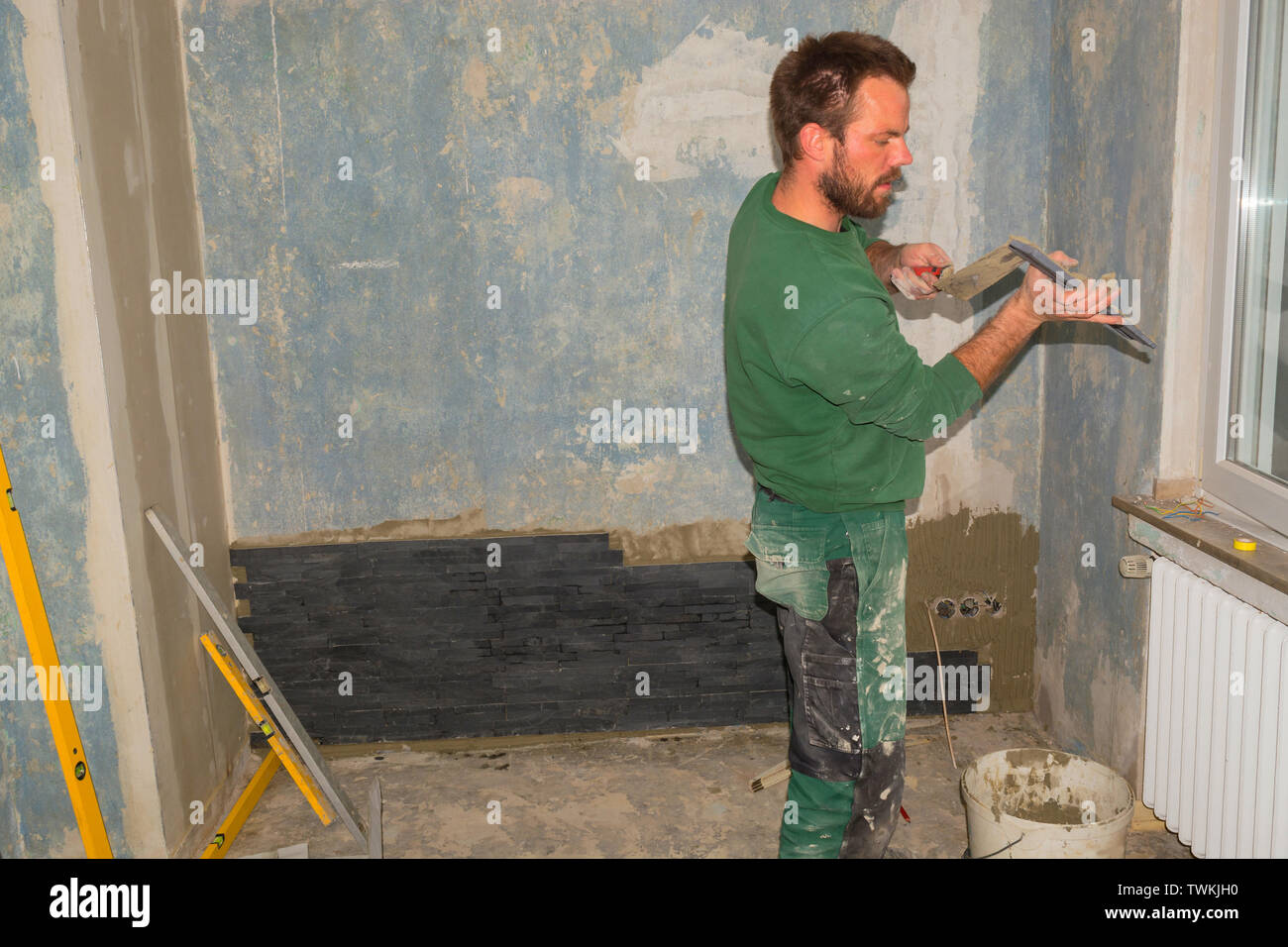 Tiler install ceramic retro straps clinker tiles Stock Photo - Alamy