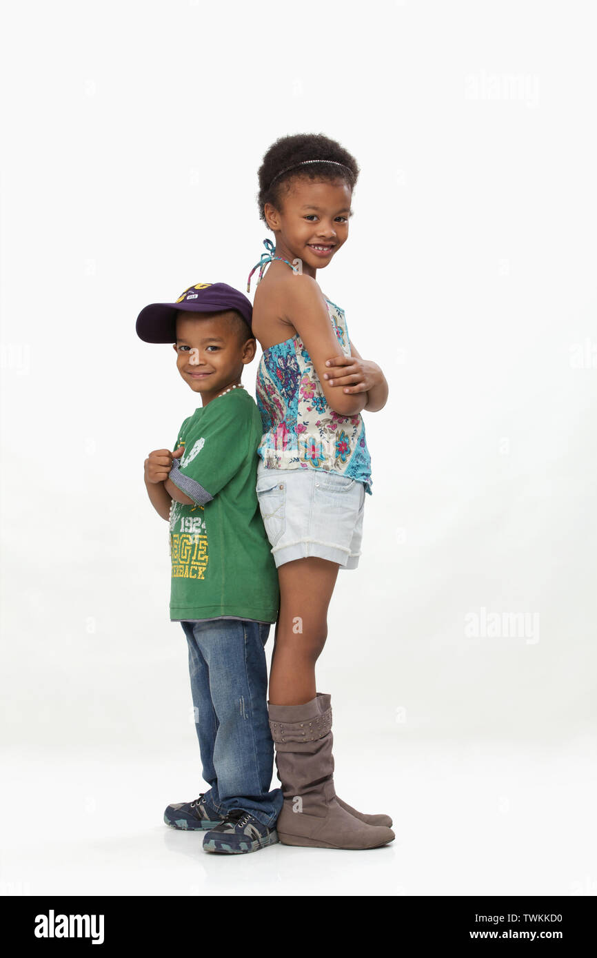 Two children standing back to back Stock Photo - Alamy