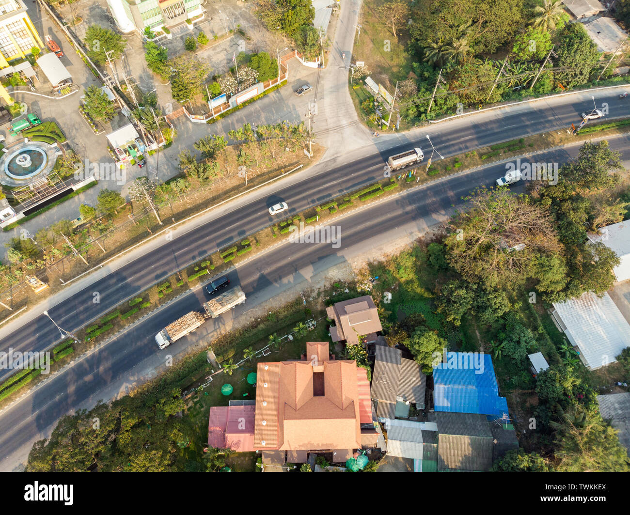 Aerial view of traffic on highway with building and nature in evening ...