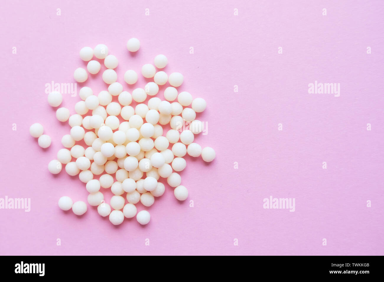 homeopathic globules on pink background. Alternative Homeopathy ...