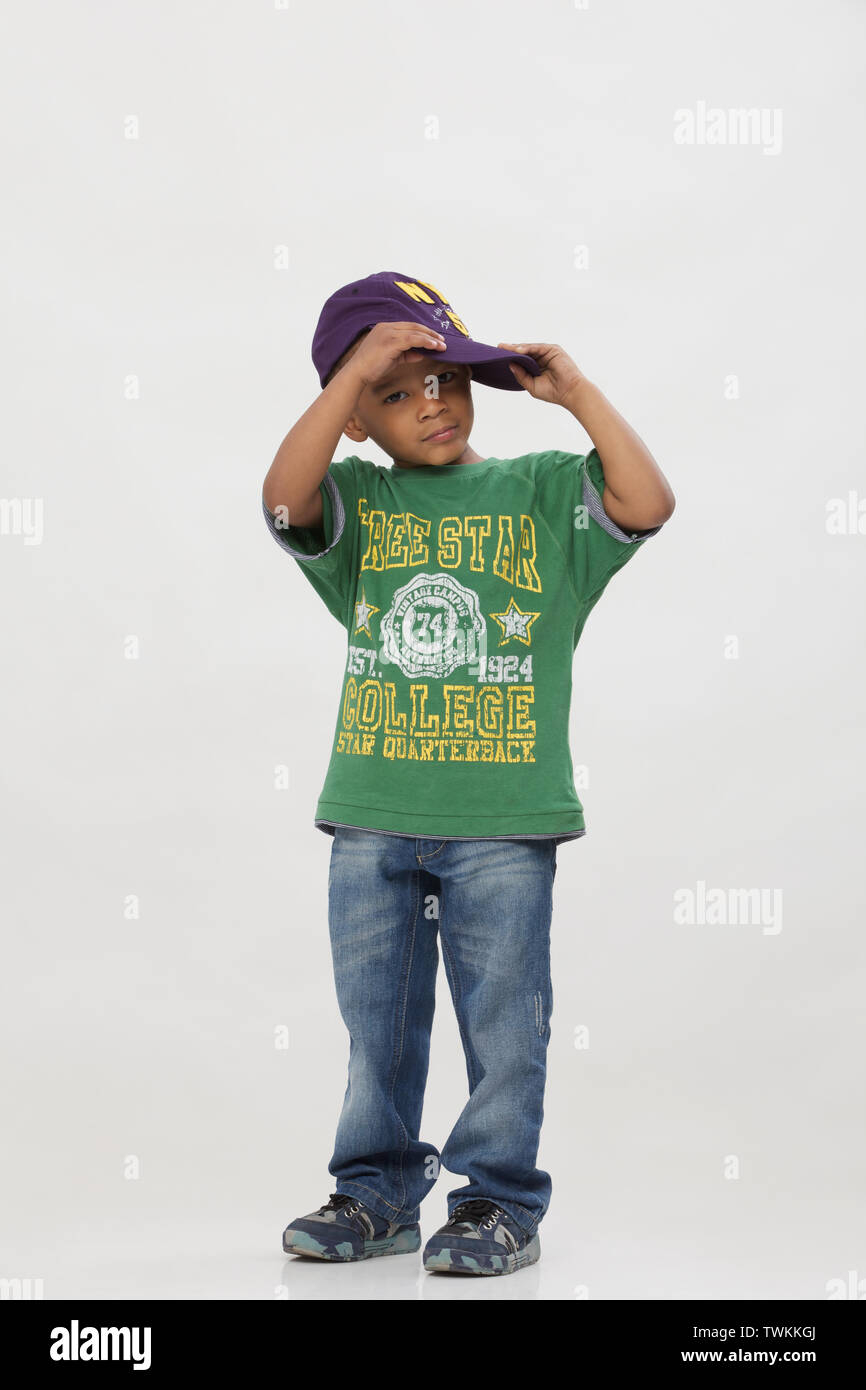 Boy adjusting his cap Stock Photo - Alamy