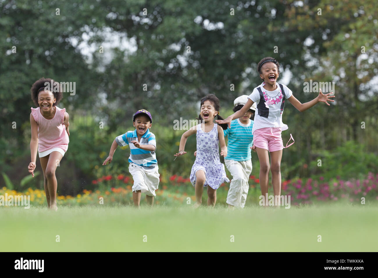 Children running in a lawn Stock Photo - Alamy