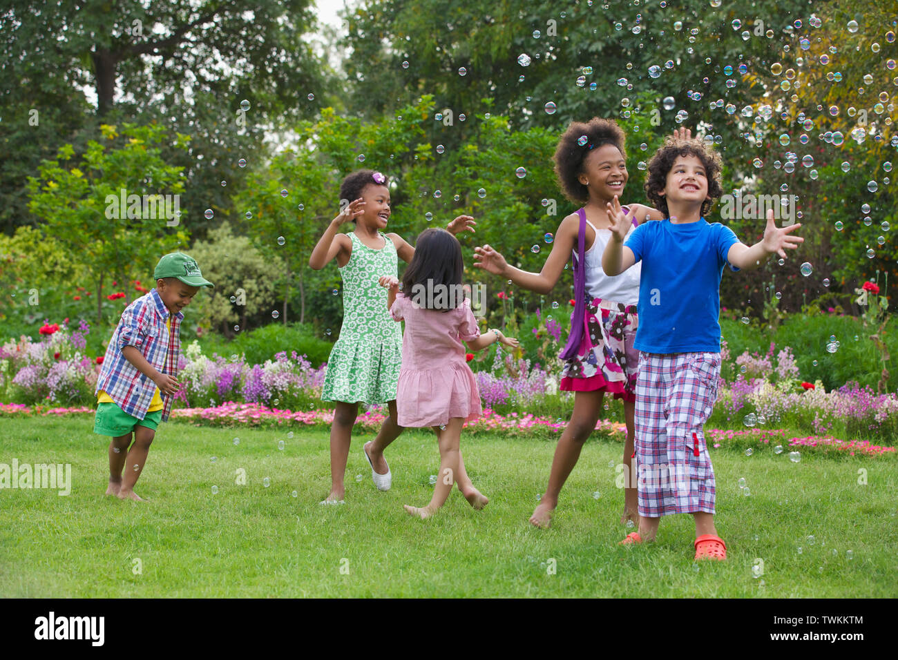 Children playing with floating bubbles Stock Photo - Alamy