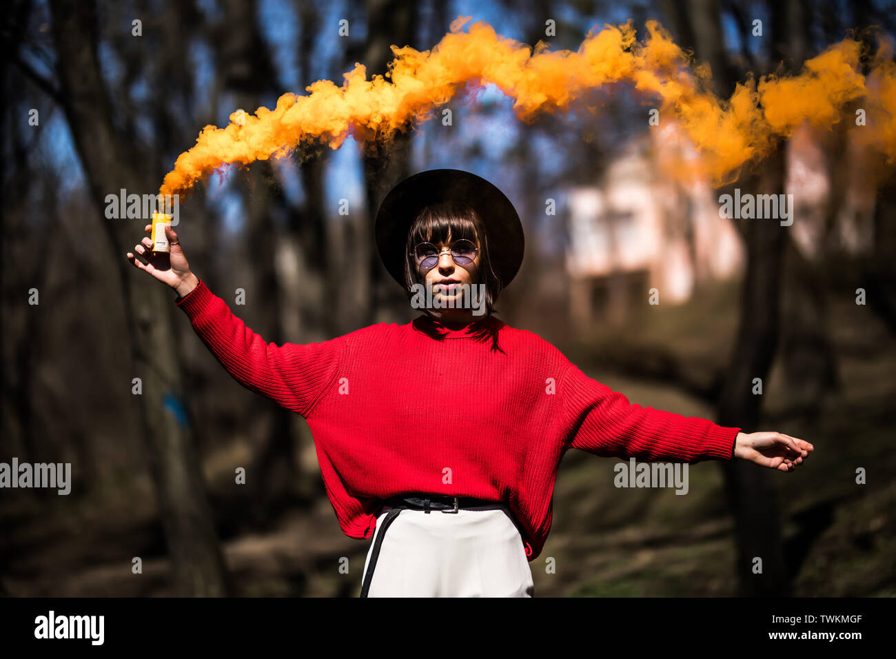 Girl with red smoke bomb. Hipster girl send smoke signal. Emergency ...