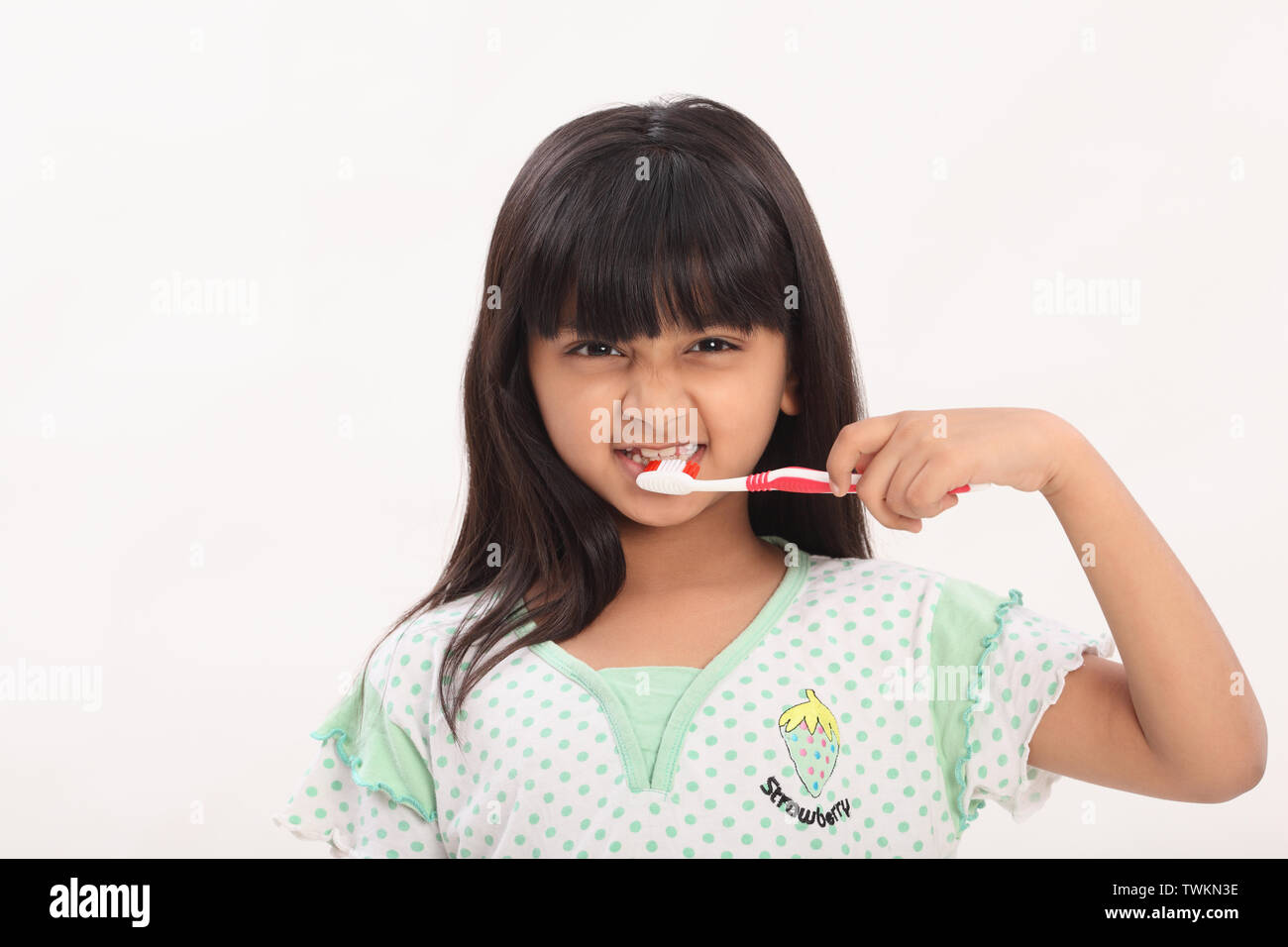Portrait of a girl brushing her teeth Stock Photo - Alamy