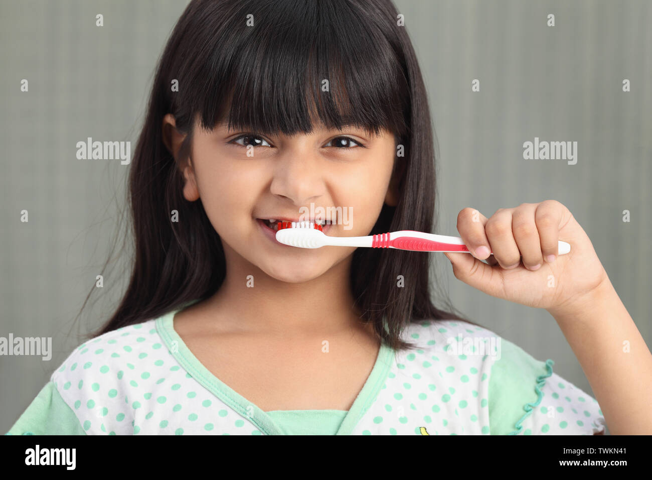 Portrait of a girl brushing her teeth Stock Photo - Alamy