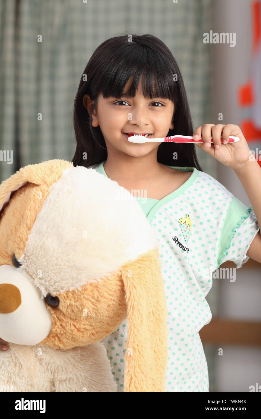 Portrait of a girl brushing her teeth Stock Photo - Alamy