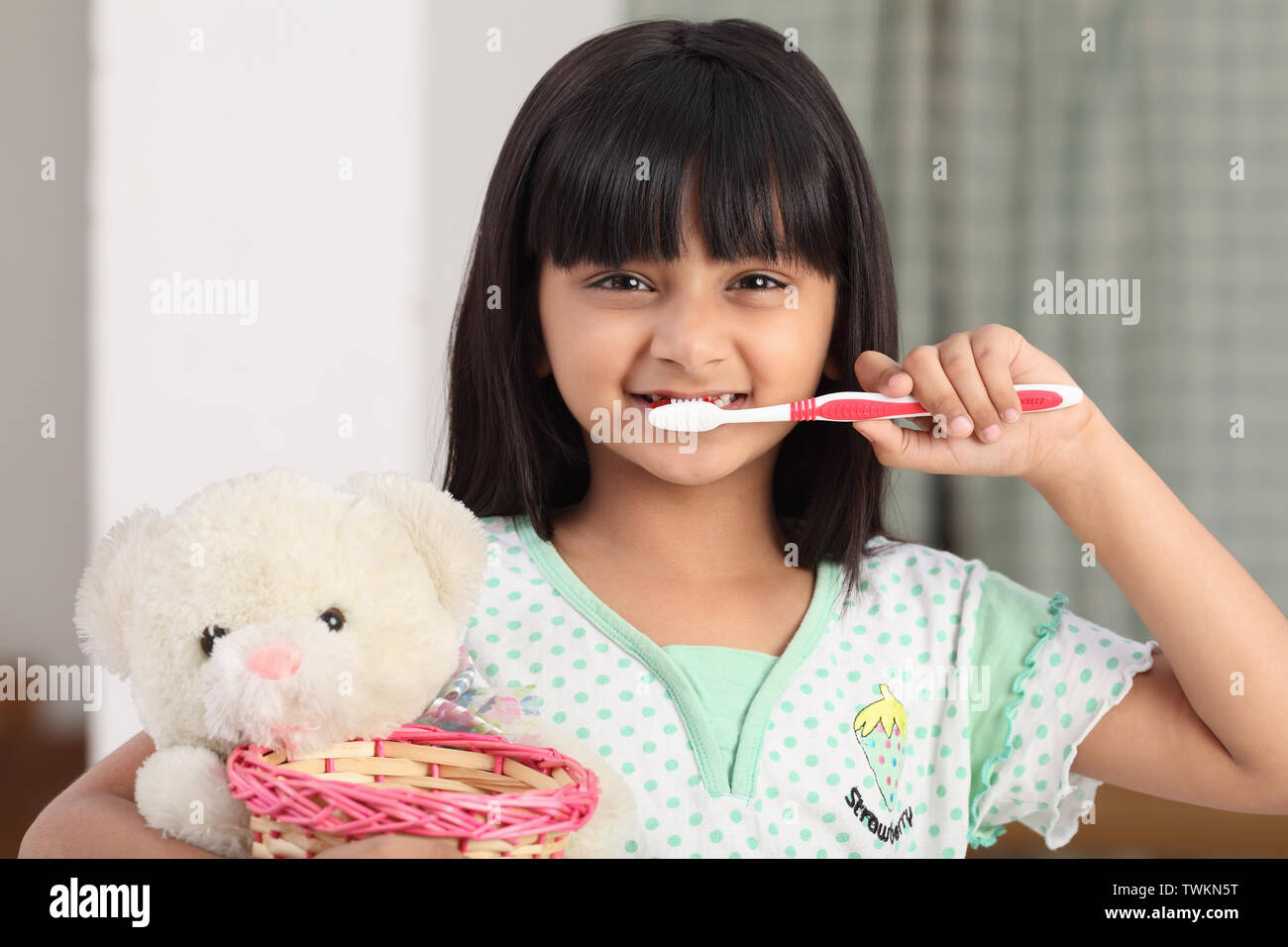 Portrait of a girl brushing her teeth Stock Photo - Alamy