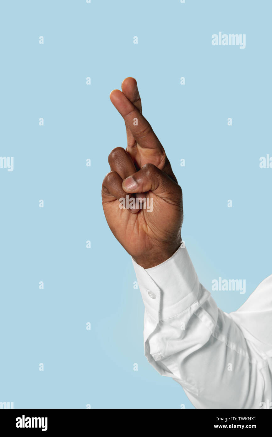 Male hand in white shirt demonstrating a gesture of waiting of good ...
