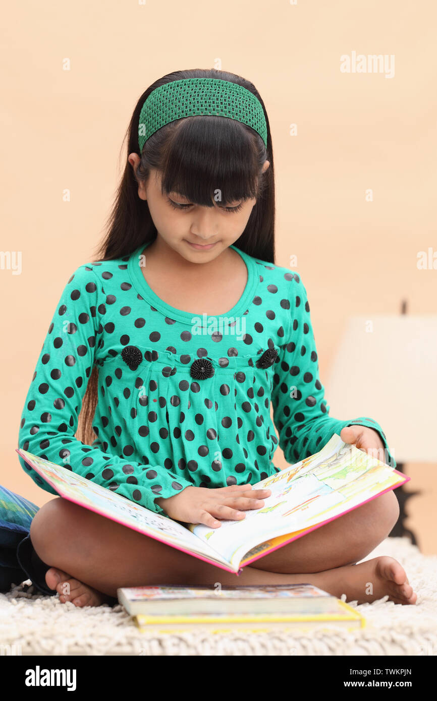 Girl reading a book Stock Photo - Alamy