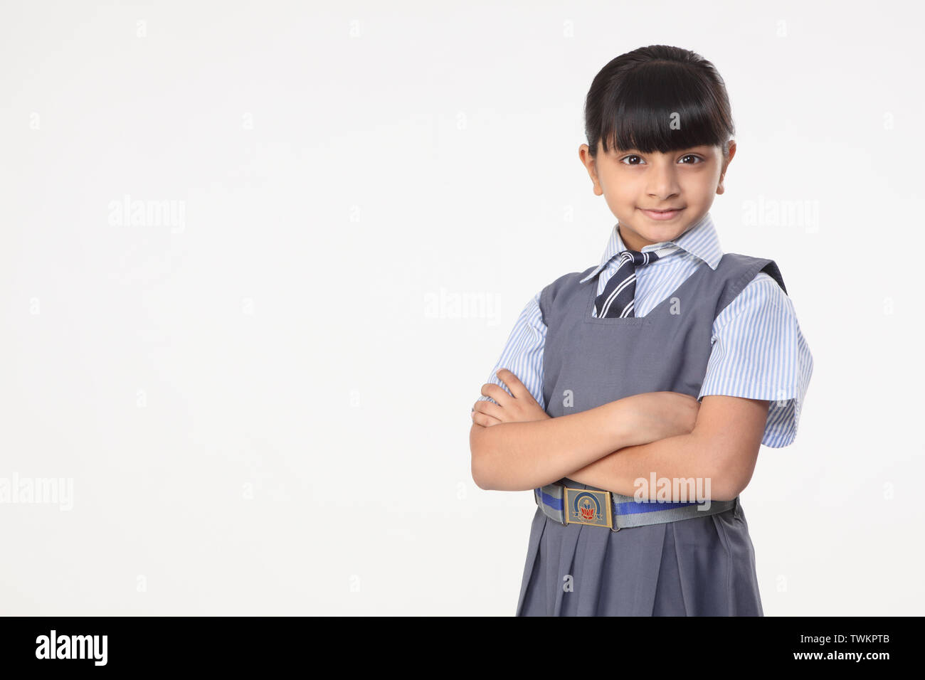 Portrait of a schoolgirl with arms crossed Stock Photo - Alamy