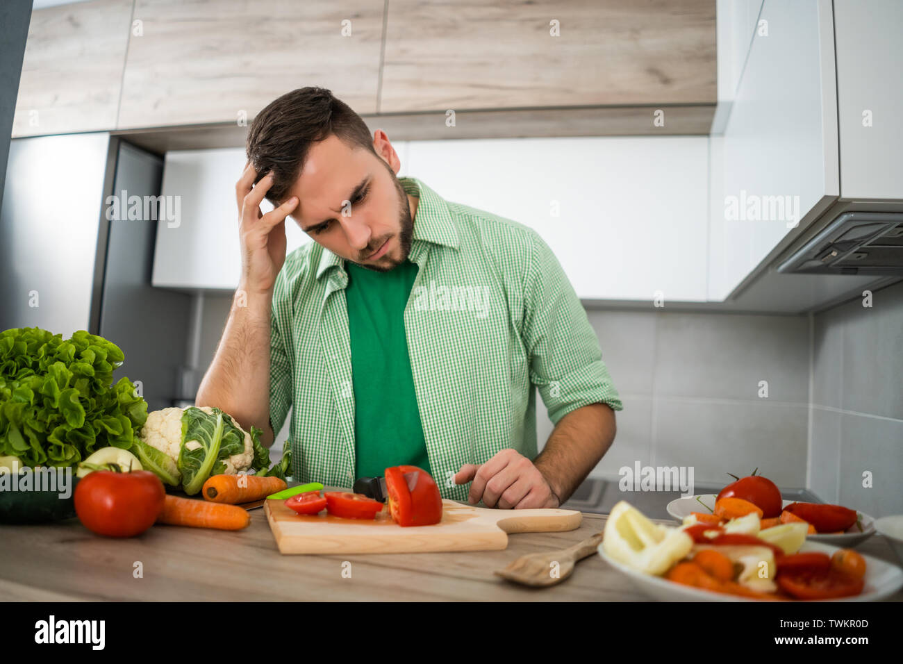 Young man does not know what to prepare for meal Stock Photo - Alamy