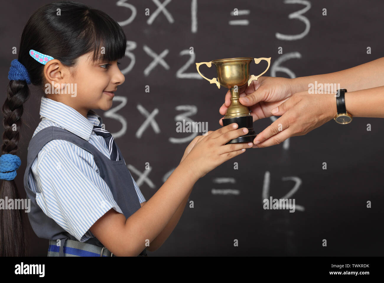 Girl being awarded trophy Stock Photo - Alamy
