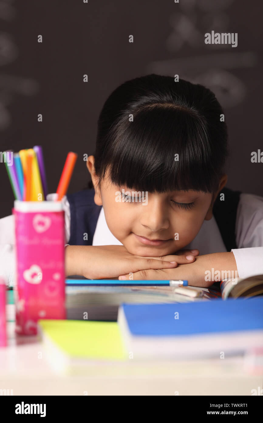 Schoolgirl napping on a desk in a classroom Stock Photo - Alamy